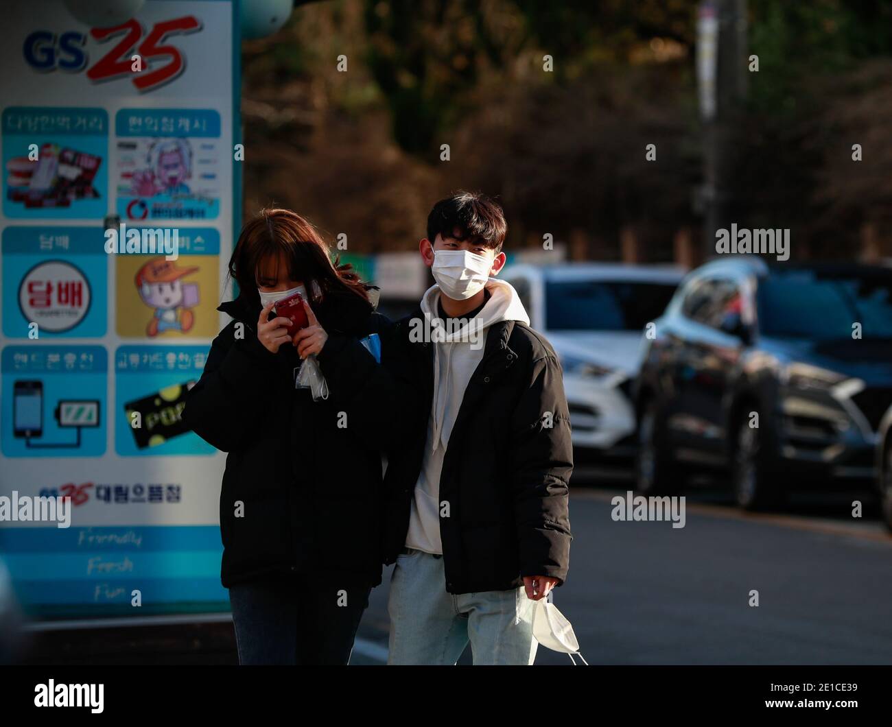 Seoul, South Korea. 6th Jan, 2021. People wearing face masks walk past ...
