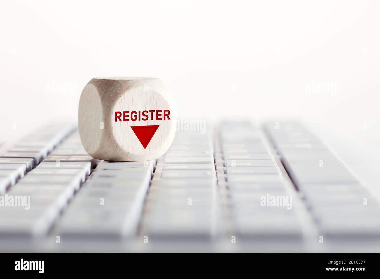 The word register with arrow icon on wooden cube with computer keyboard ...