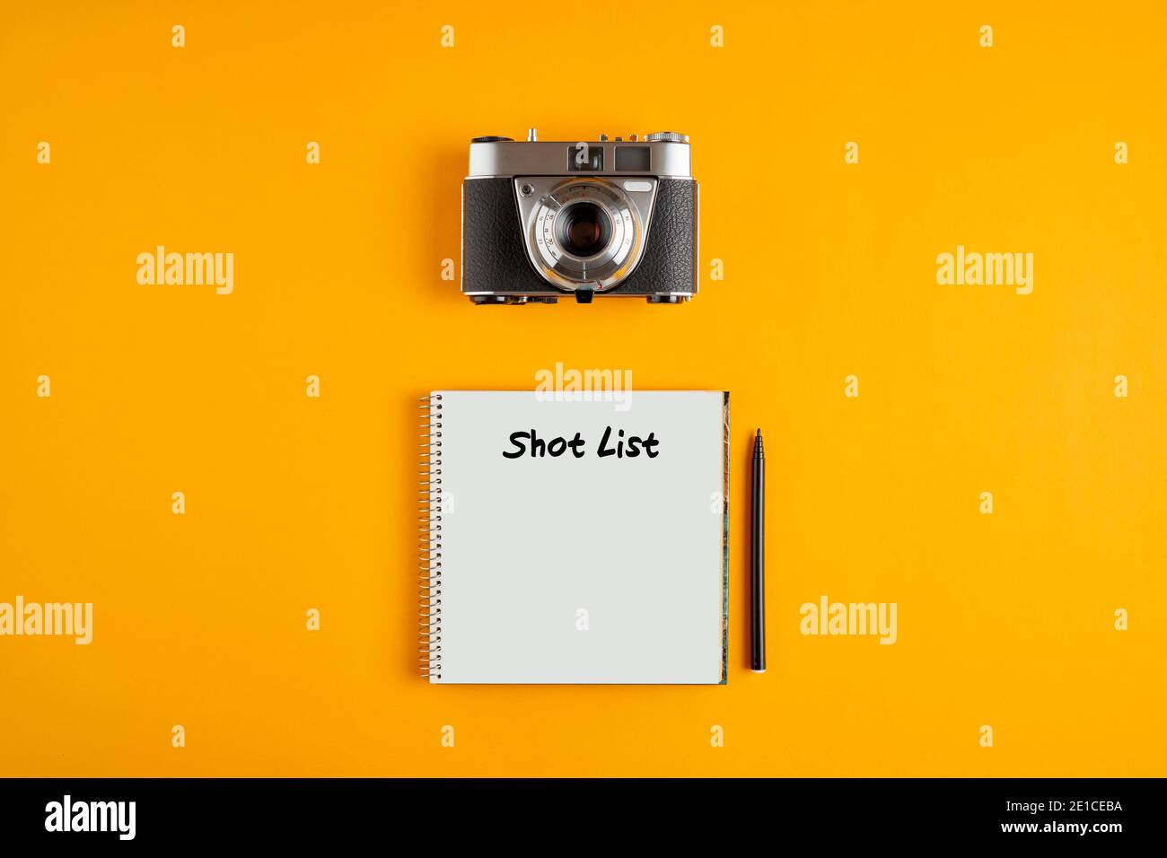 Vintage camera with a notebook with the words shot list written against ...