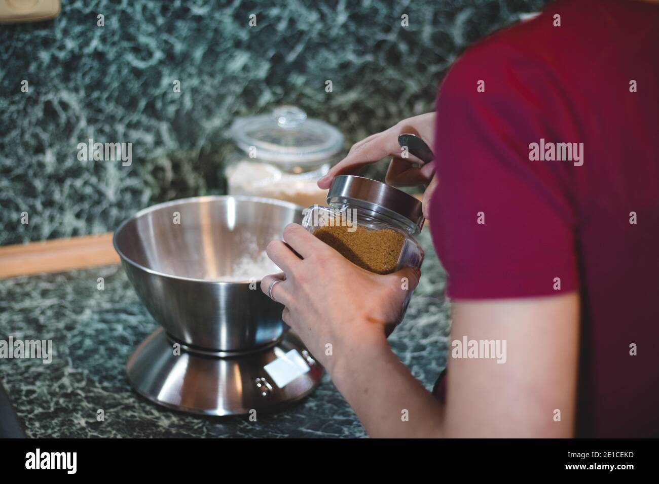 cook weighs the sugar on an electronic scale to determine the exact ...