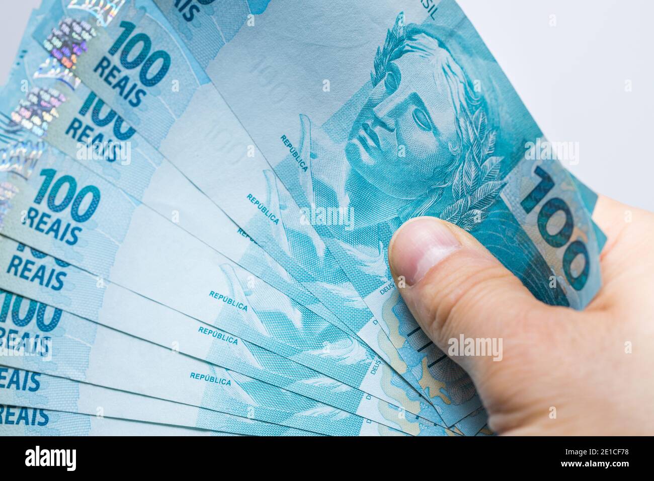 Brazilian money, Lots of 100 Reais banknotes in your hand Stock Photo ...