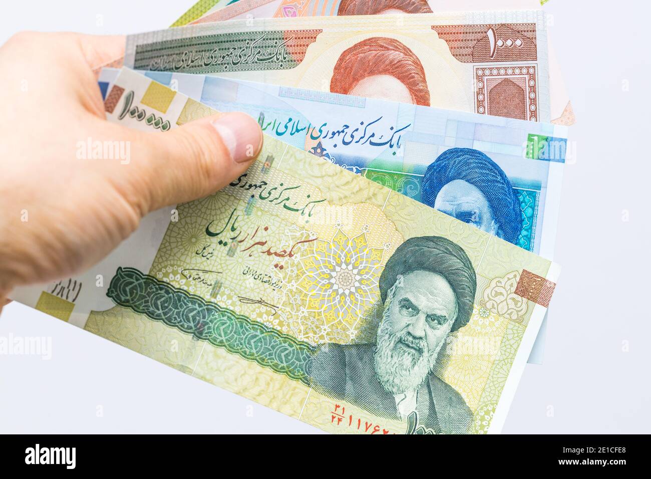 Iranian money, Riyal, Banknotes held in the hand Stock Photo - Alamy