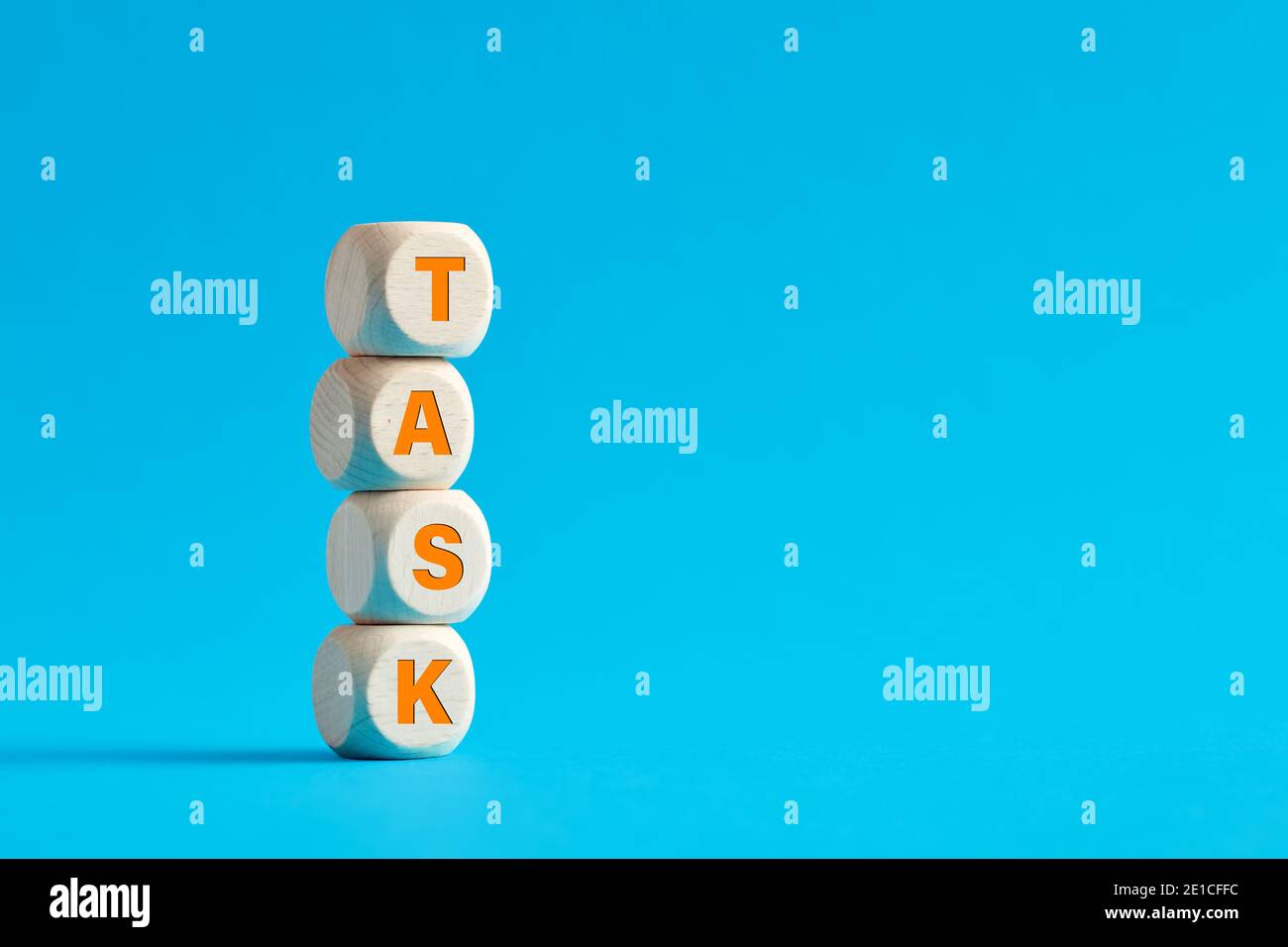 The word task on tiered wooden cubes on blue background. Task ...