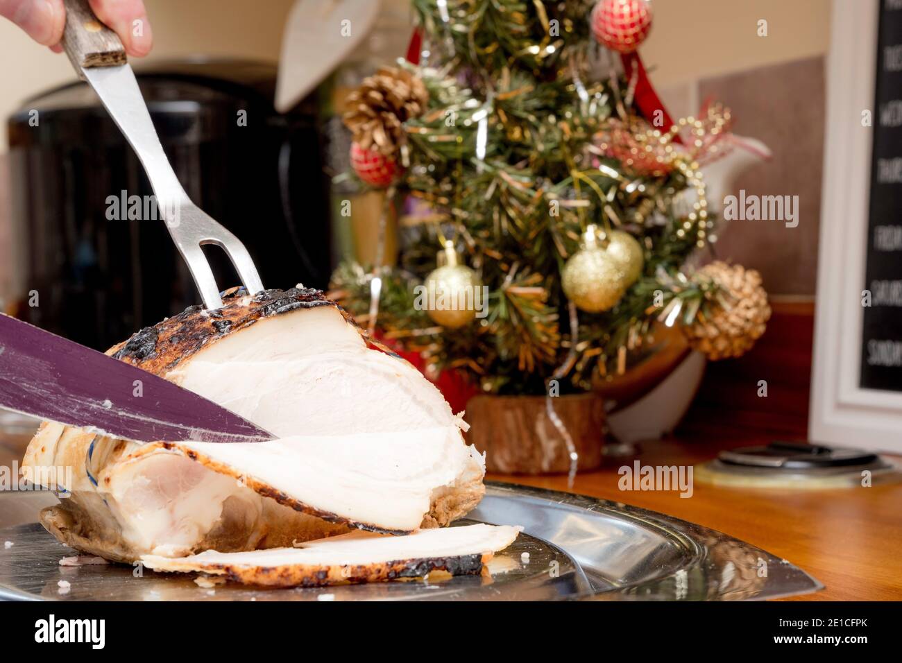 Folk and Knife cutting the Pork, Christmas Day Stock Photo - Alamy