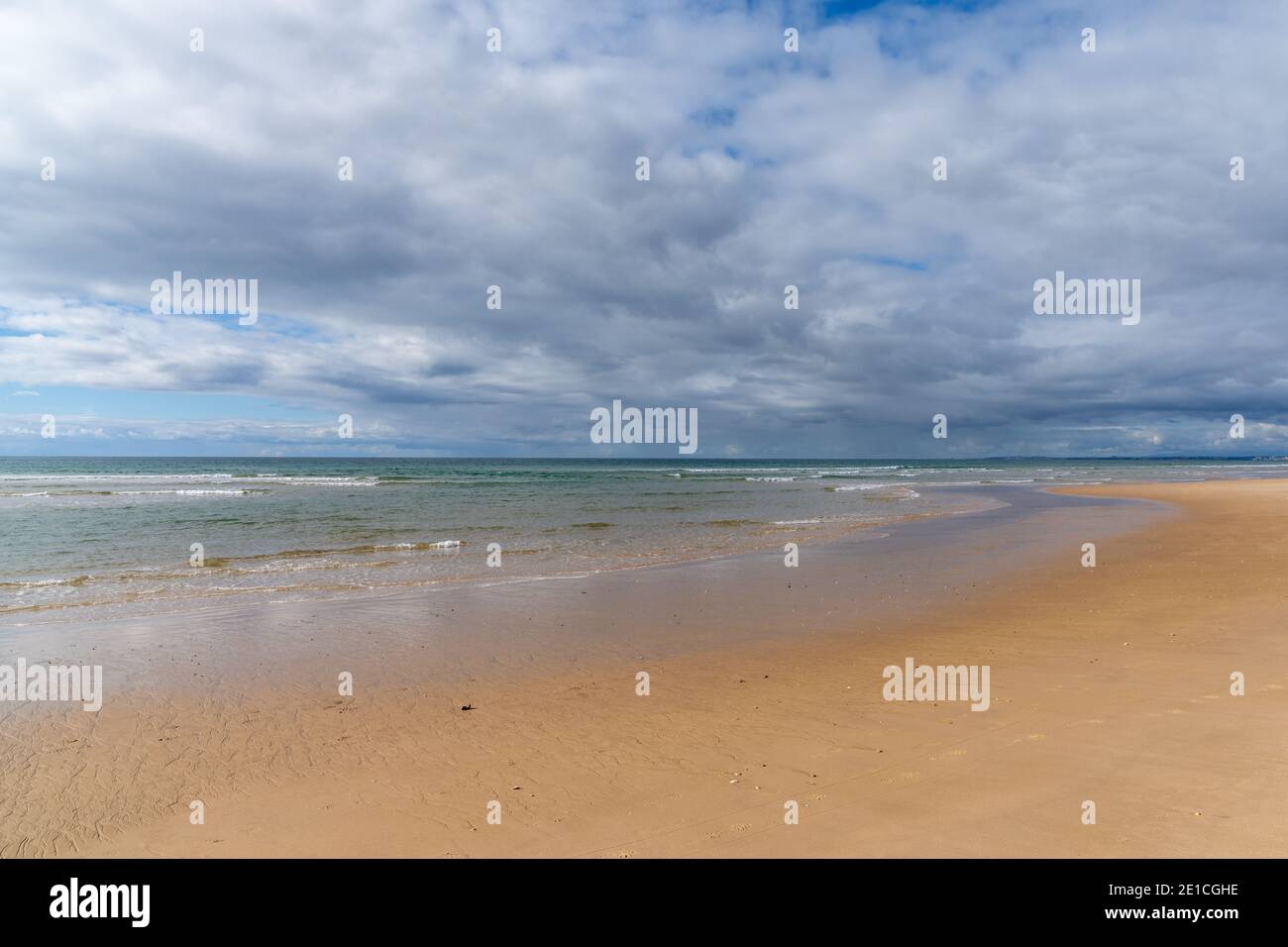 A beautiful wide empty golden sand beach on the Algarve in Portugal ...