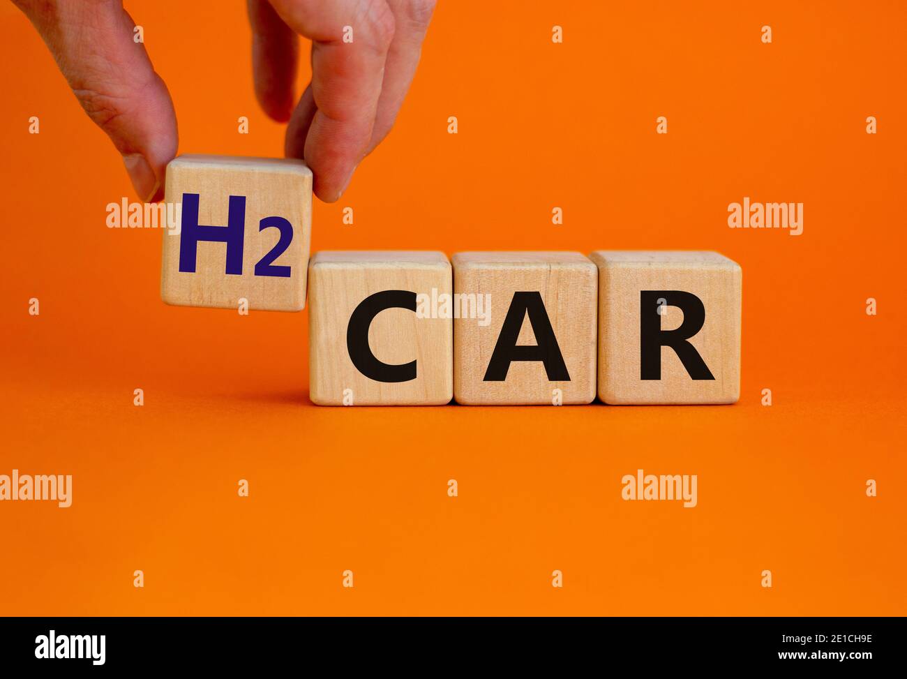 H2 hydrogen car symbol. Businesman hand holds wooden cubes with the ...