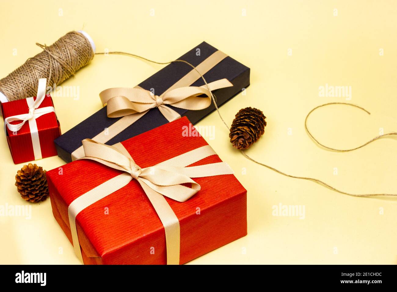 Several gifts and packing tape on a yellow background. Gift wrapping ...