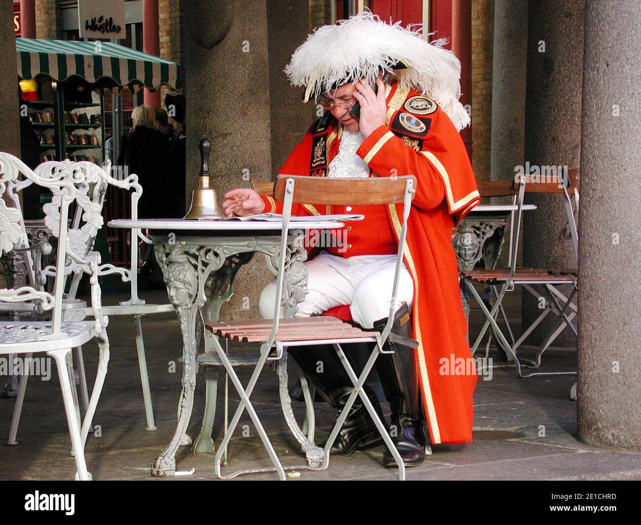 Traditional Town Crier using mobile phone with bell Covent garden ...