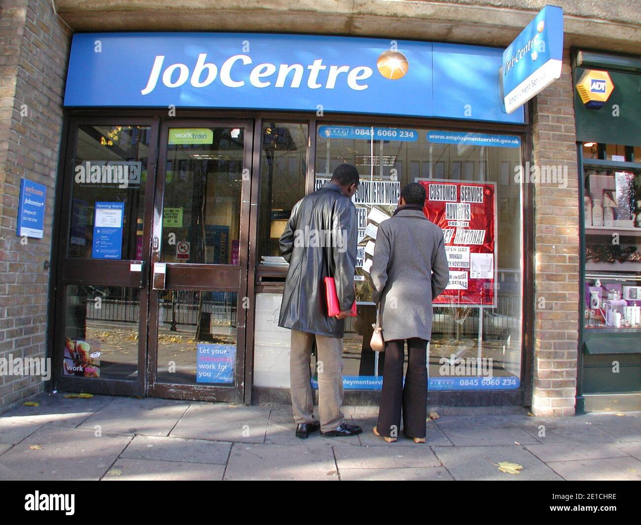 Job seekers look for situations vacant in window of Job Centre ...