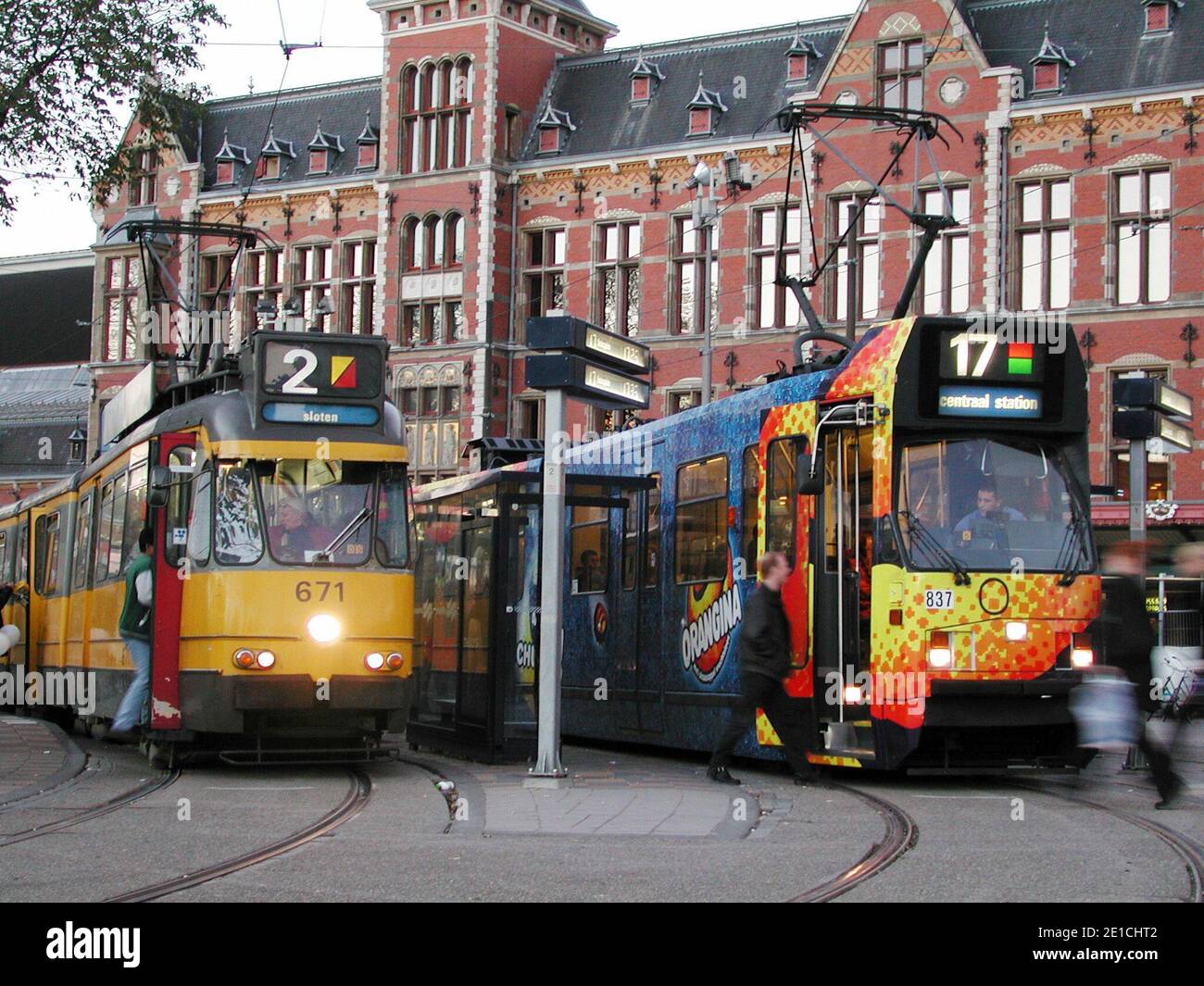 Trams at Centraal railway and tram Station Amsterdam Holland ...