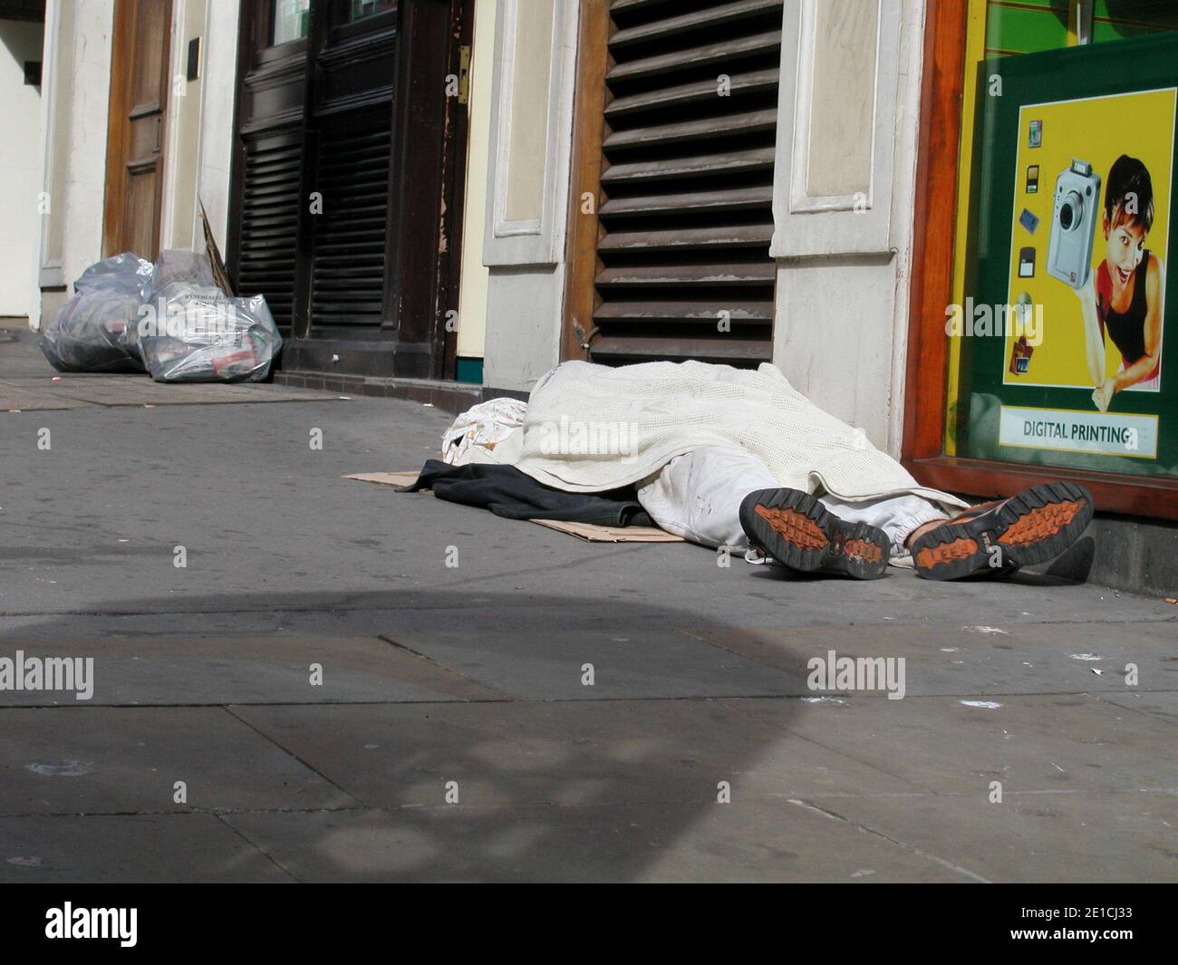 Homeless destitute tramp asleep on street near The Strand Inland ...