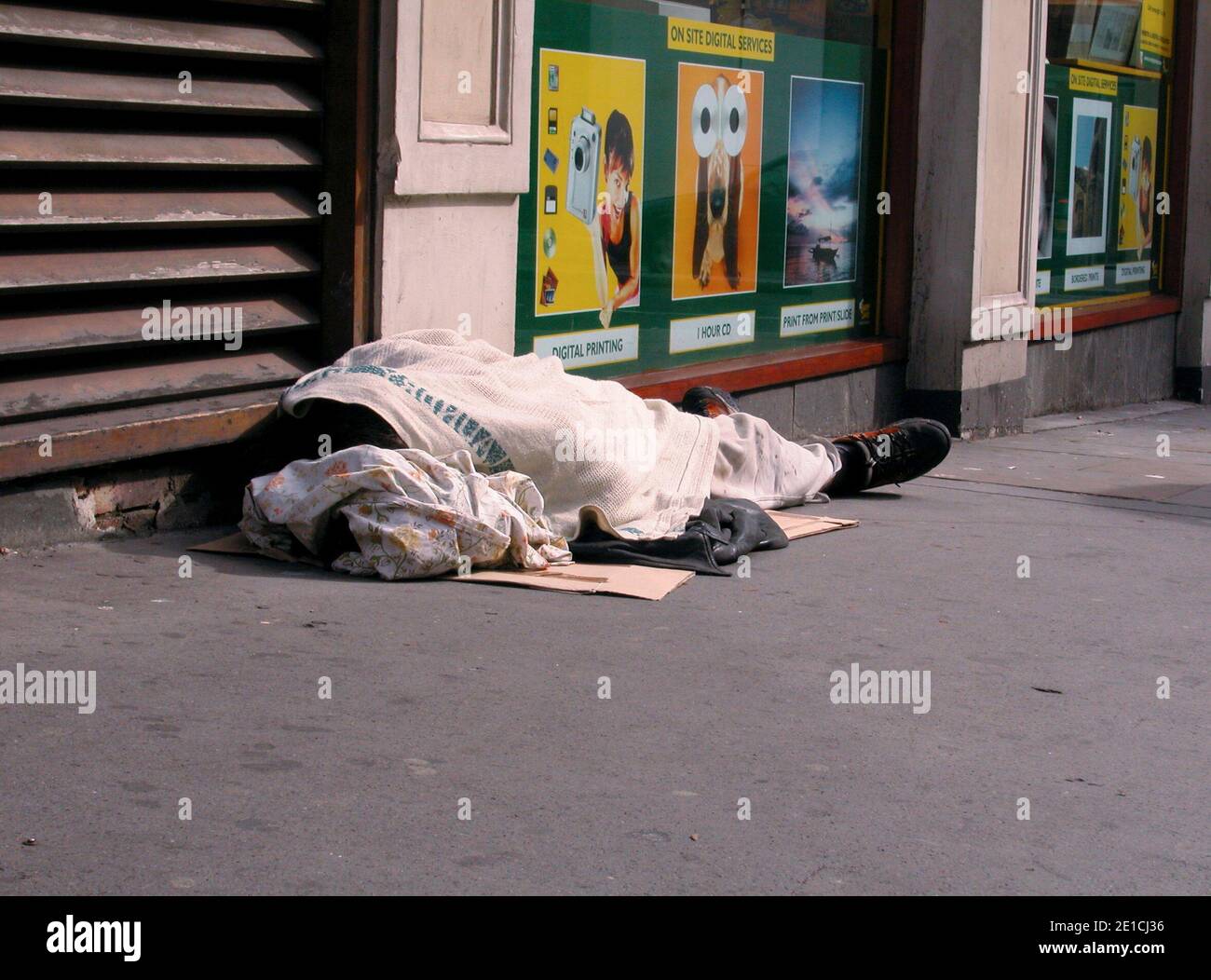 Homeless destitute tramp asleep on street near The Strand Central ...