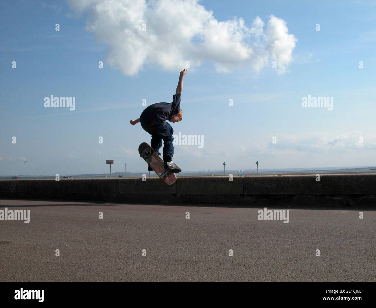Youth jumps with skateboard young boy skateboarder displaying skills on ...