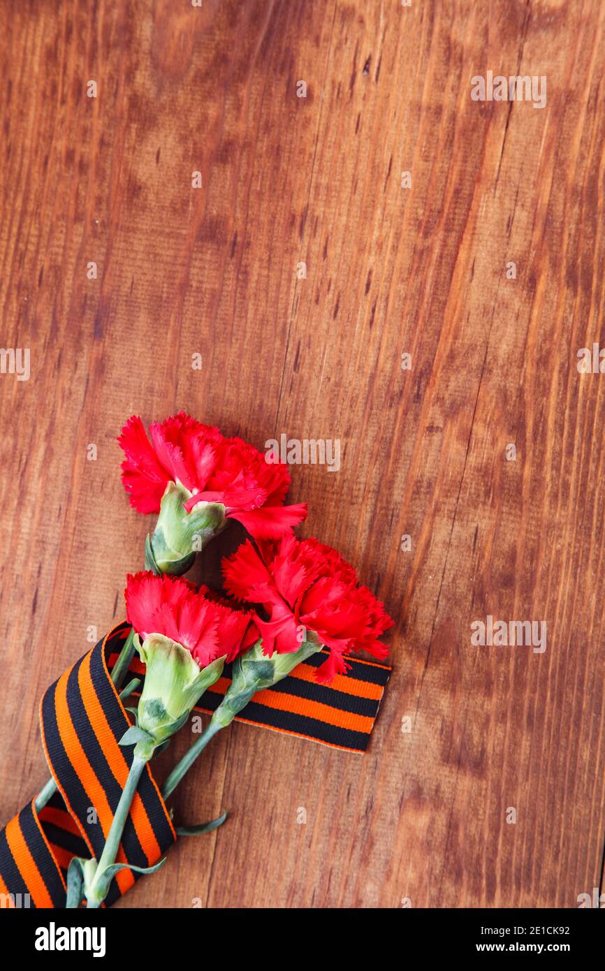 three red flower Symbols of Victory in Great Patriotic War on wooden ...