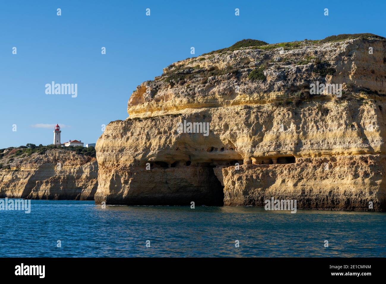 A view of the Alfanzina lighthouse on the beautiful Algarve coast of ...