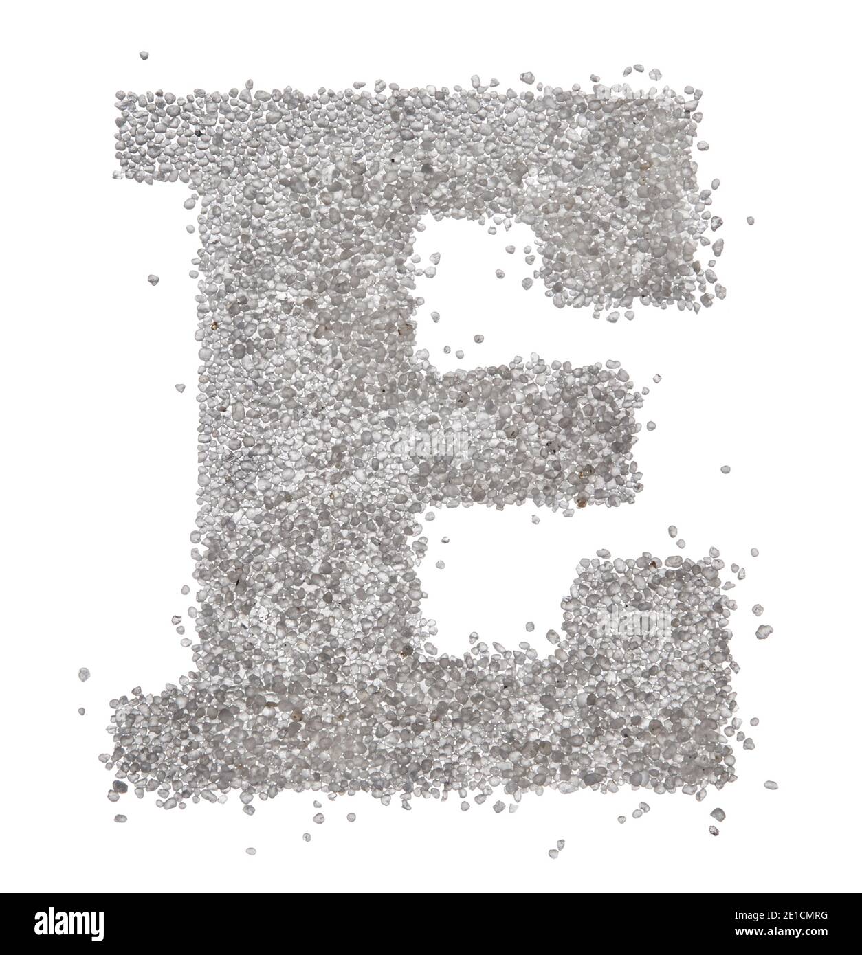 Serif sand letter capital E with sharp edges photographed on a white ...