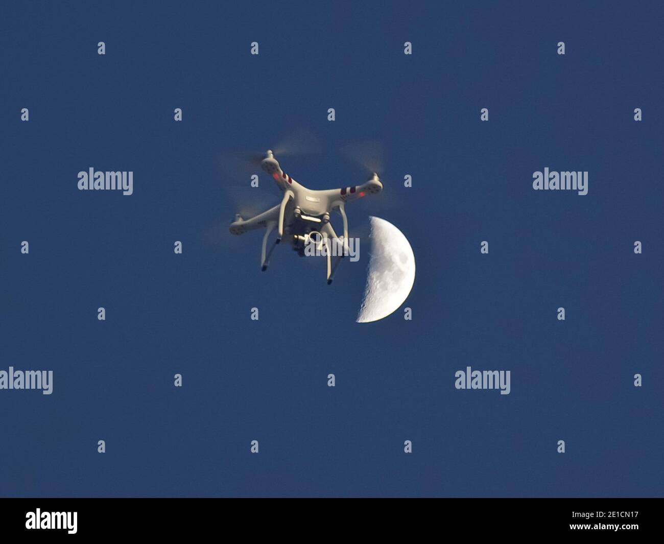 Drone against the moon and blue sky. Flying drone with camera Stock ...