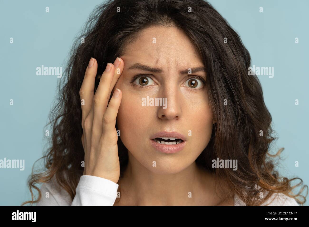 Worried woman has signs of aging skin, checking crows feet troubled ...