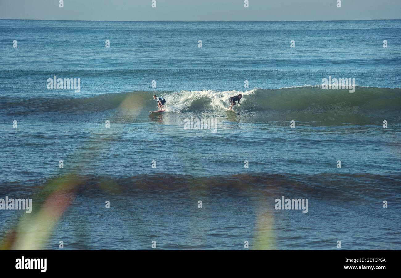 friends splitting wave peak in nicaragua Stock Photo - Alamy