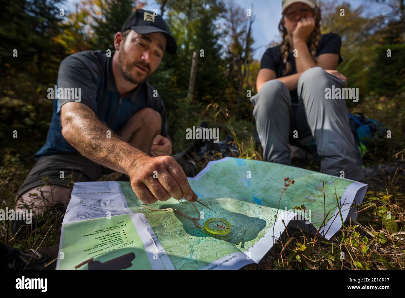 Hikers planning trip with map, Adirondack Mountains, New York State ...