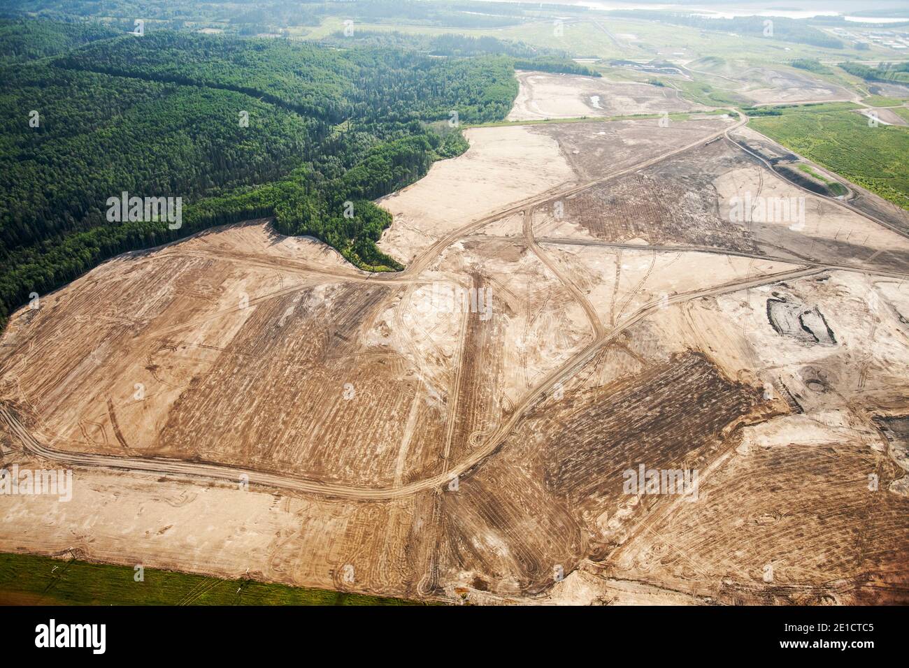 Soil overburden being removed to reach the tar sands beds in an open ...