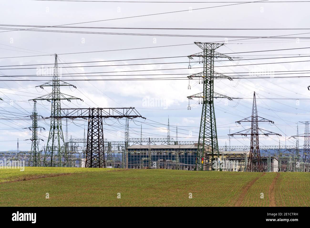Electricity pylons conducting current from distribution power station ...