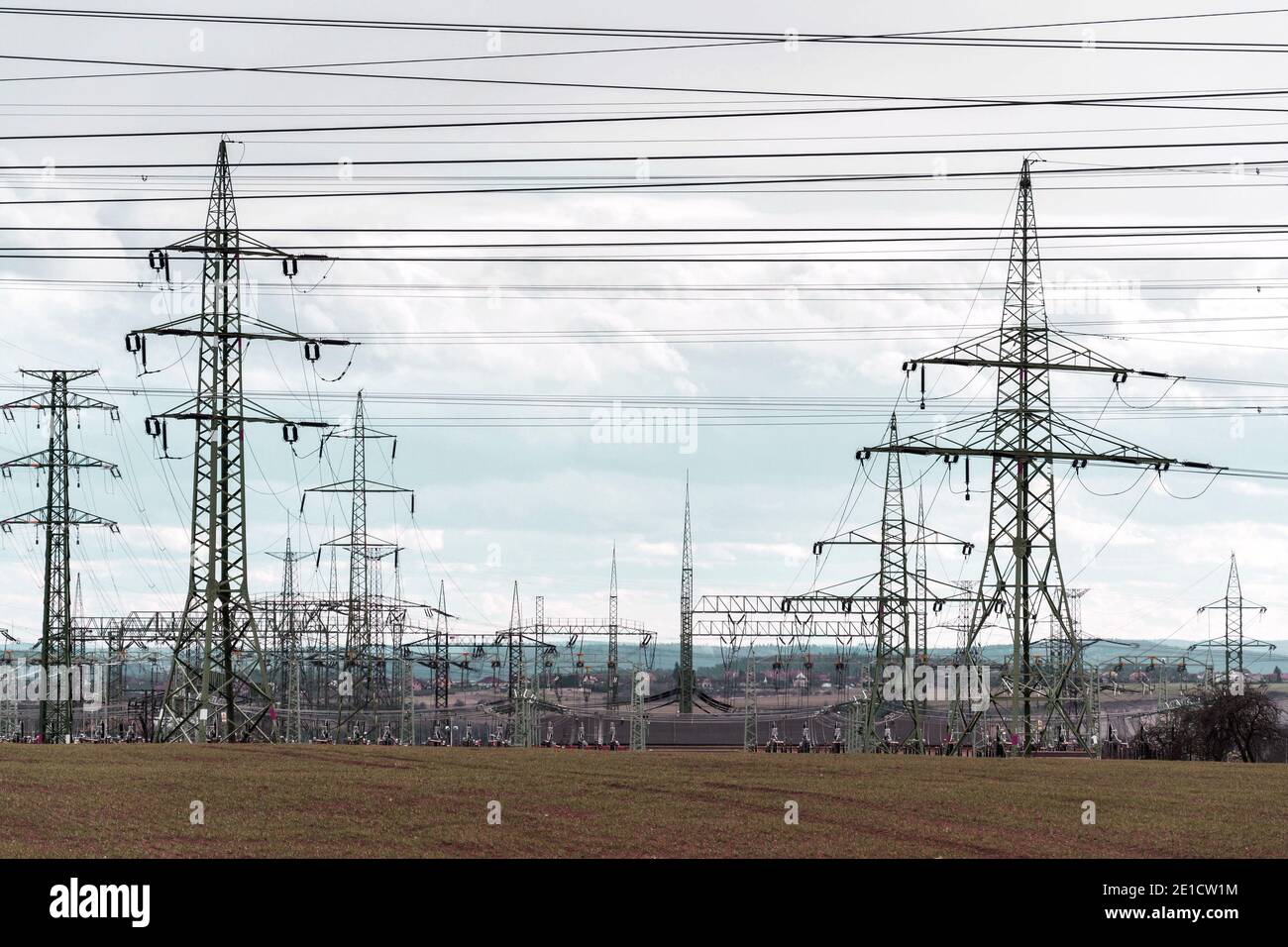 Electricity pylons conducting current from distribution power station ...