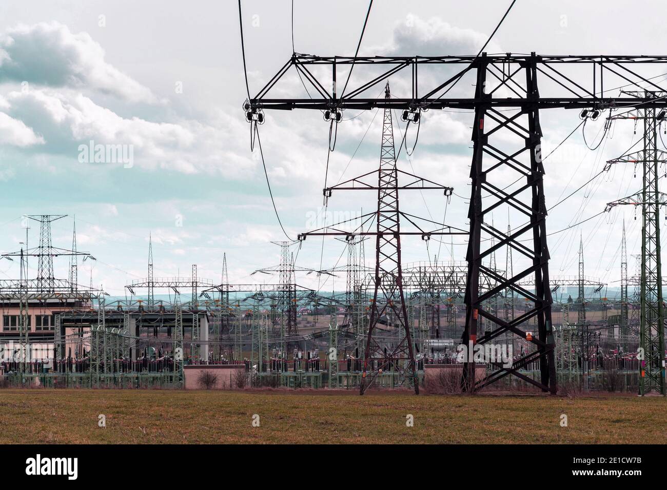 Electricity pylons conducting current from distribution power station ...