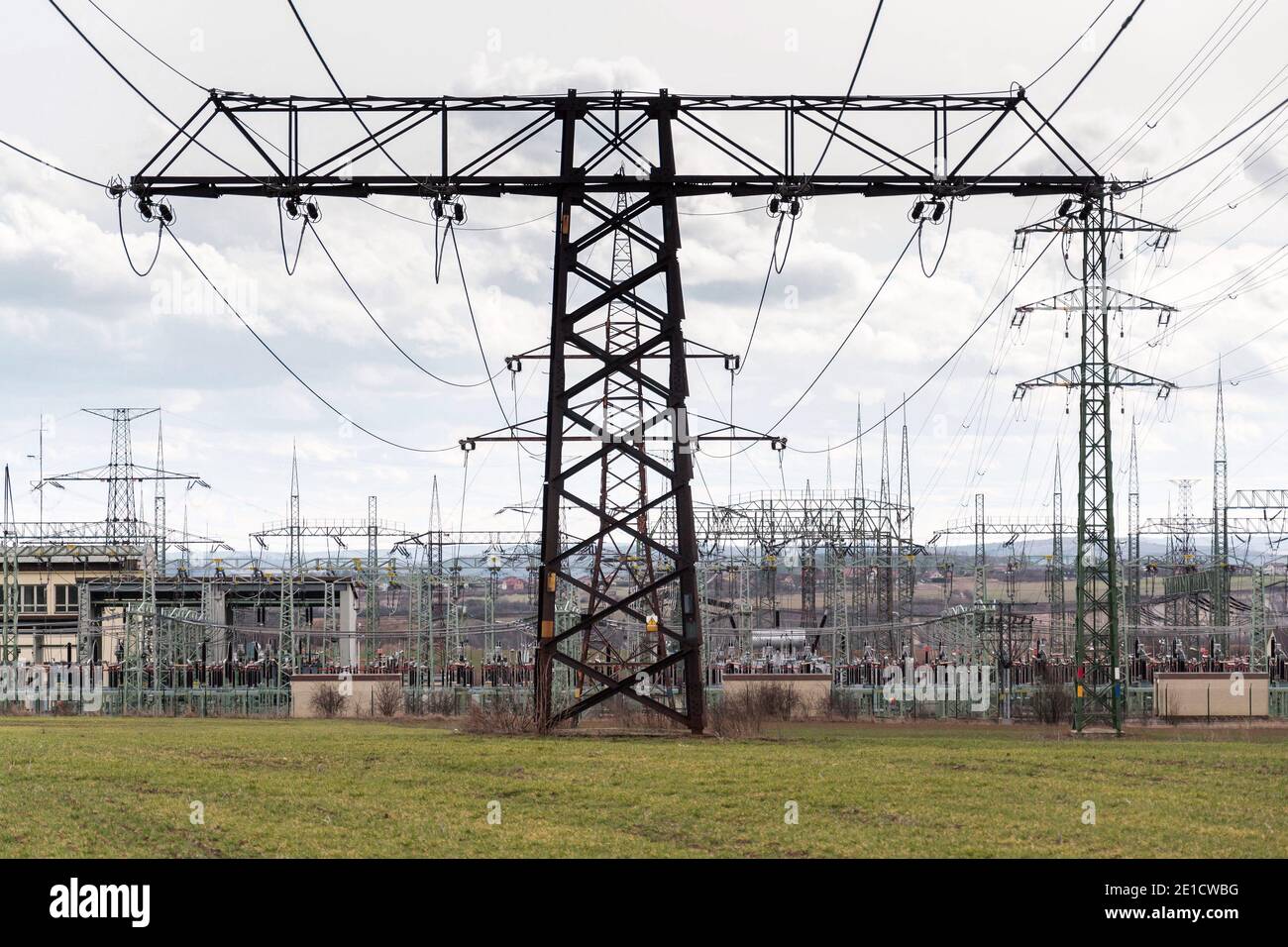 Electricity pylons conducting current from distribution power station ...
