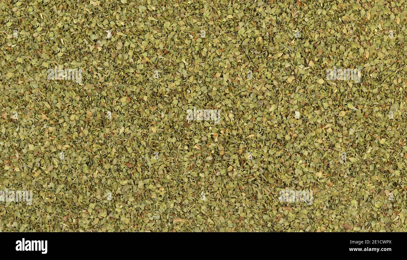 Dry marjoram spice (Origanum majorana). Heap of ground marjoram leaves ...