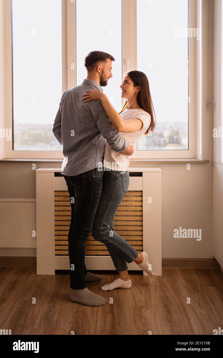 Portrait loving couples enjoying each other company with window in ...