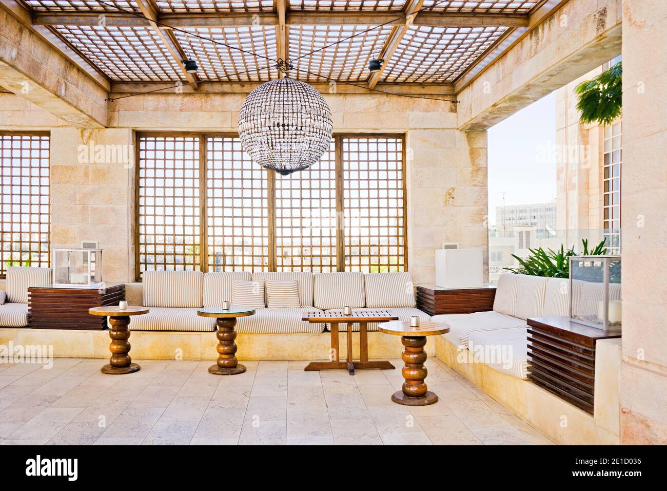 Outdoor rooftop lounge with a large disco ball type chandelier and ...