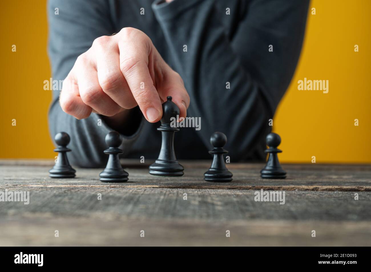 Conceptual image of strategy and power with male hand positioning chess ...