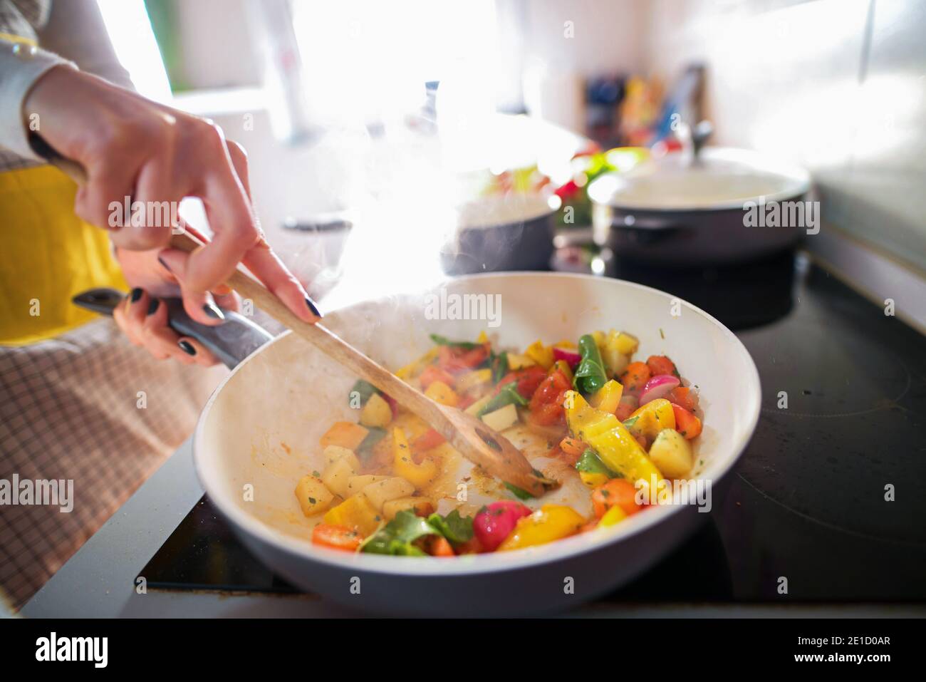 Close up of woman hands mixing food in cooking pan Stock Photo - Alamy