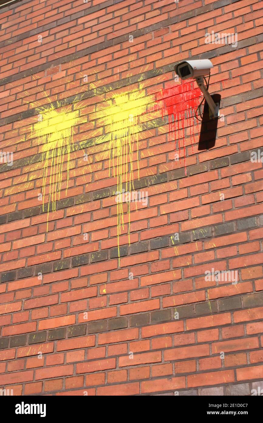 yellow and red color stains next to a surveillance camera Stock Photo ...