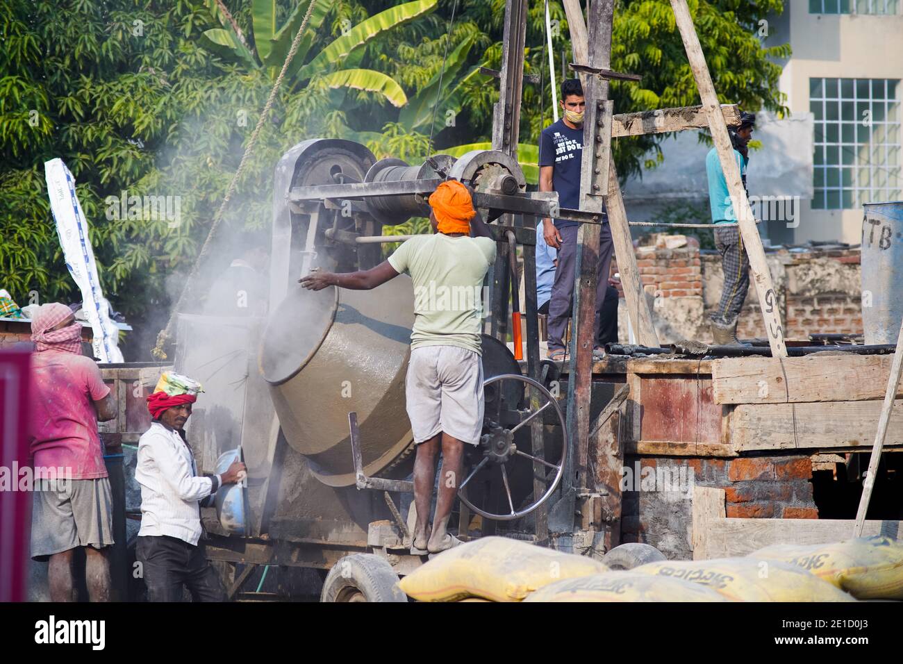 Wide angle shot of a construction site with poor workers queing up to ...
