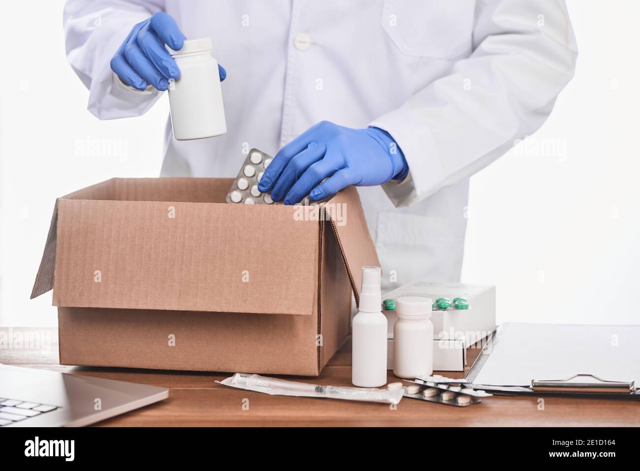 Physician putting prescribed medications into a cardboard box Stock ...