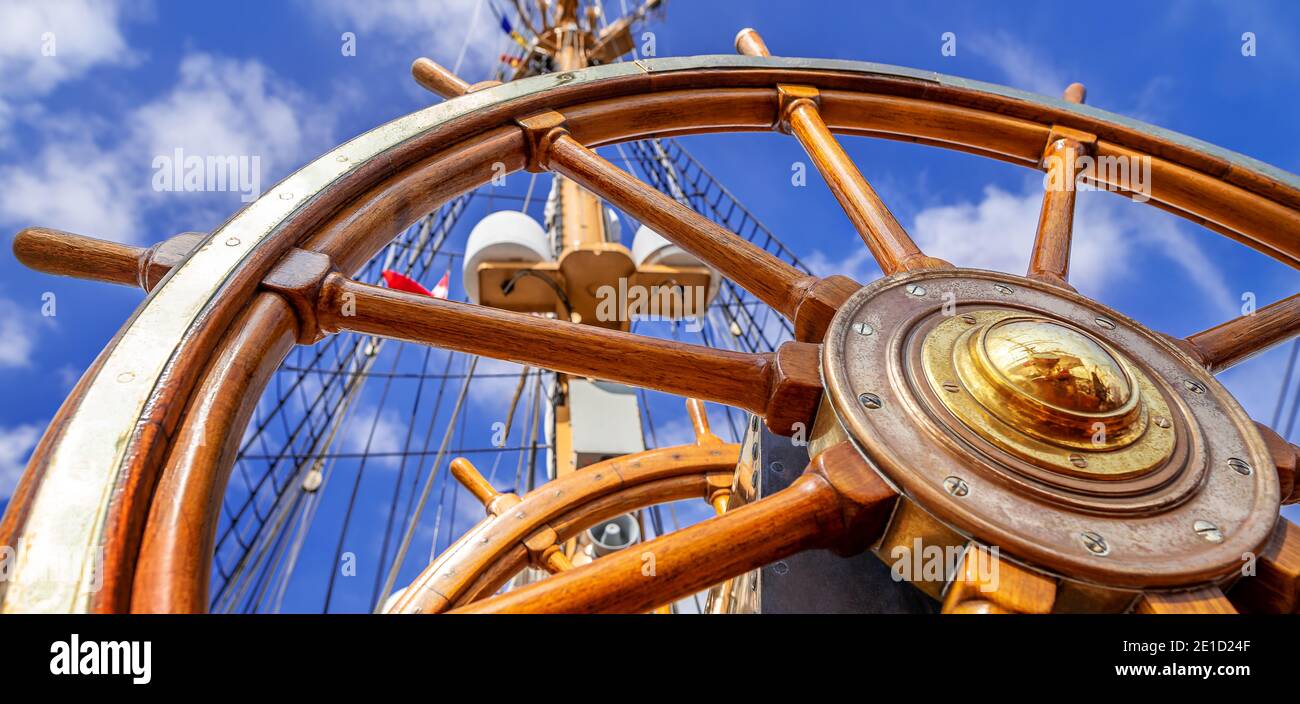 Sailor at the steering wheel of a sailing ship hi-res stock photography ...