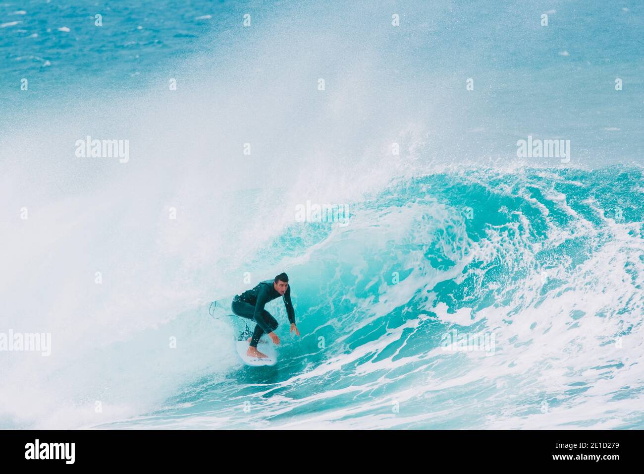 Surfer riding wave in sea Stock Photo - Alamy