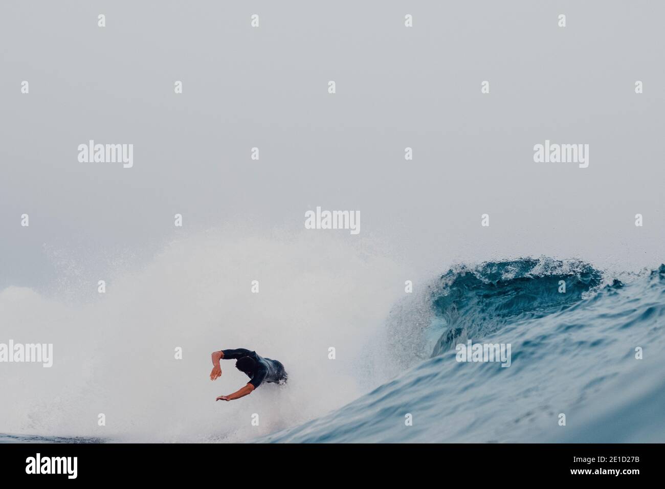 Surfer riding wave in sea Stock Photo - Alamy