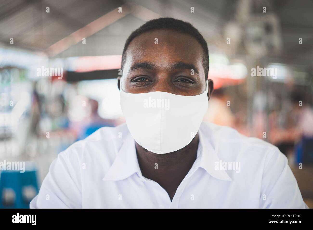 African man wearing face mask with white shirt Stock Photo - Alamy