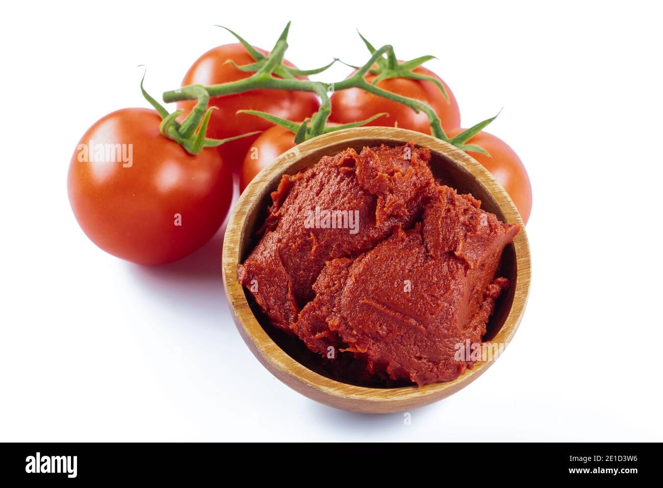 Tomatoes with a dish of tomato paste, over white background Stock Photo ...