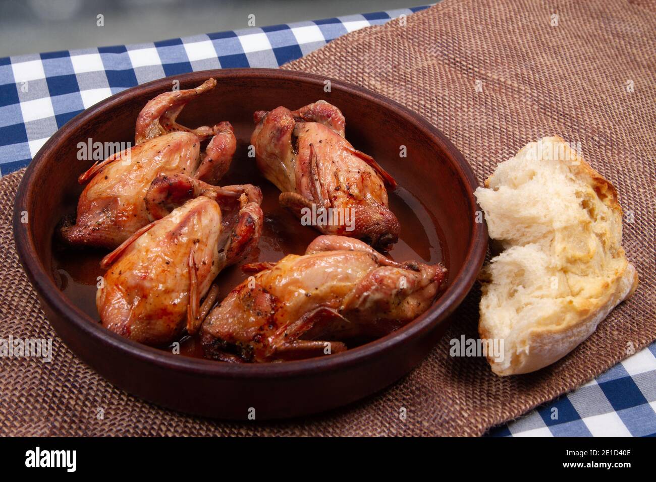 Roasted quail and Chunk of white bread. Rustic style Stock Photo - Alamy