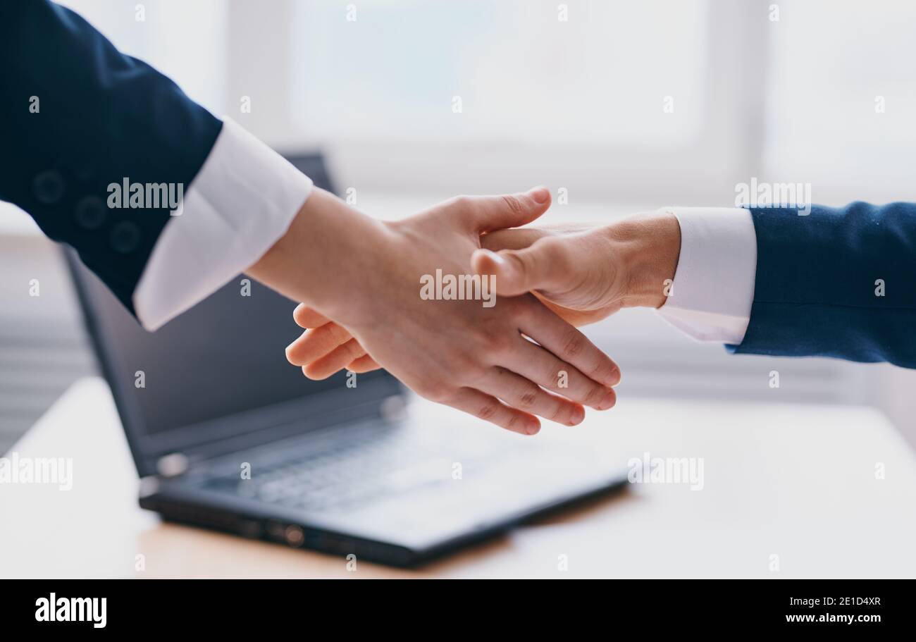 Business people shake hands at work In the office employees are mutual ...