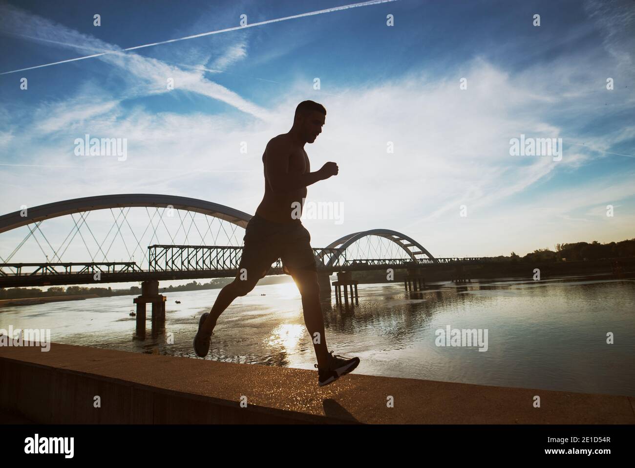Fitness training outdoors. Handsome man working exercises in early ...