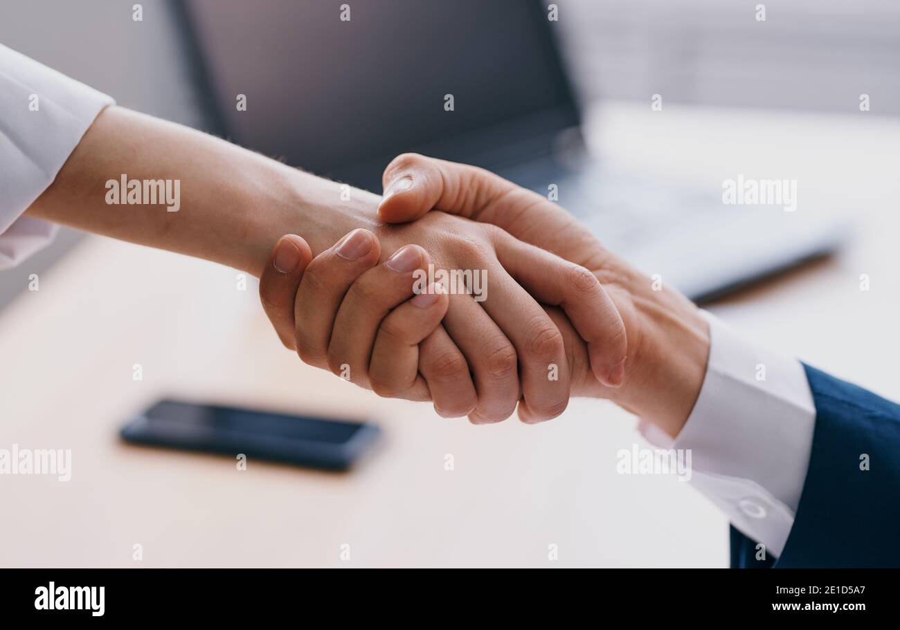 Business people shake hands at work In the office employees are mutual ...