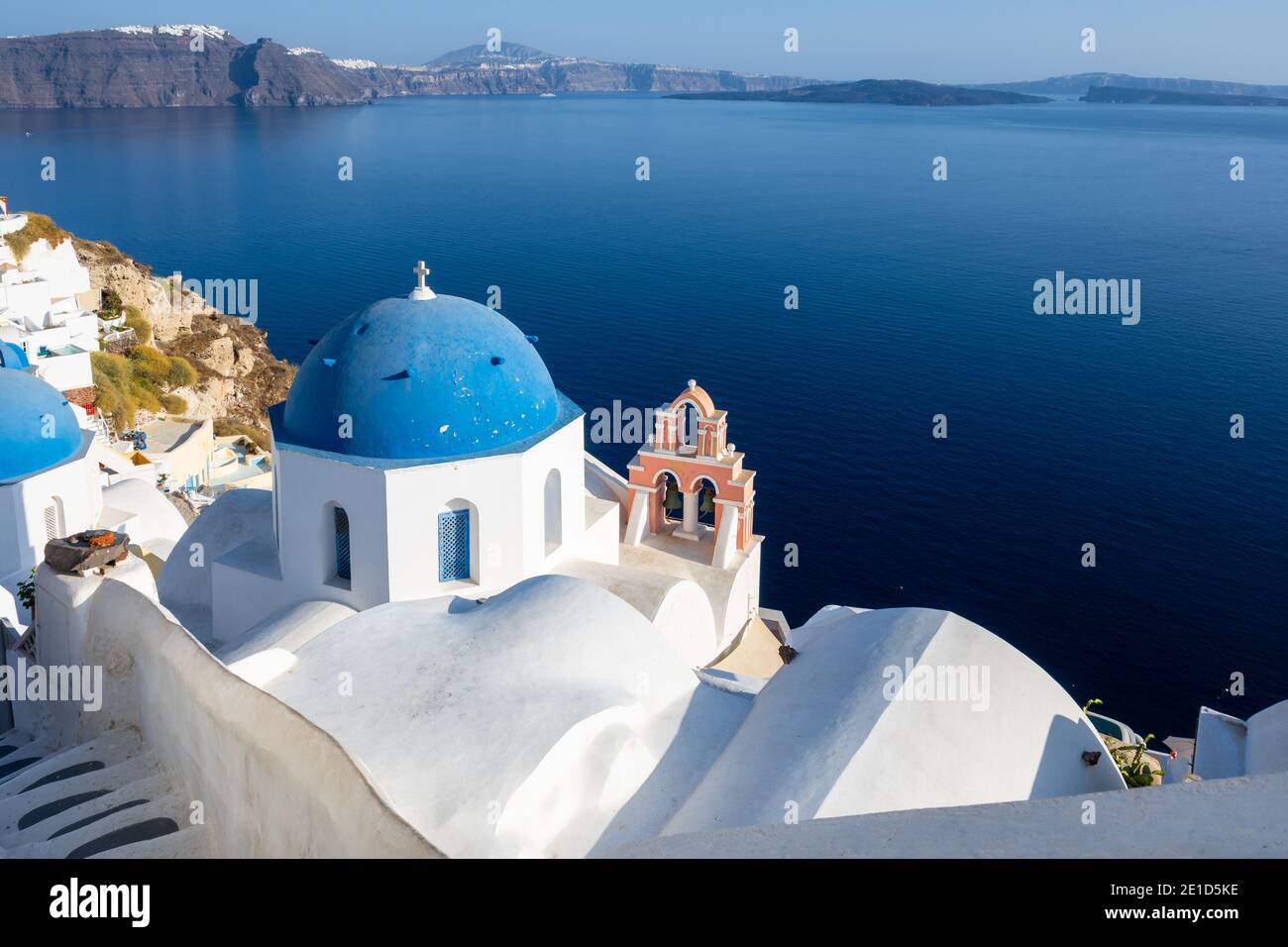 Oia village with blue dome of church building, Santorini island, Greece ...