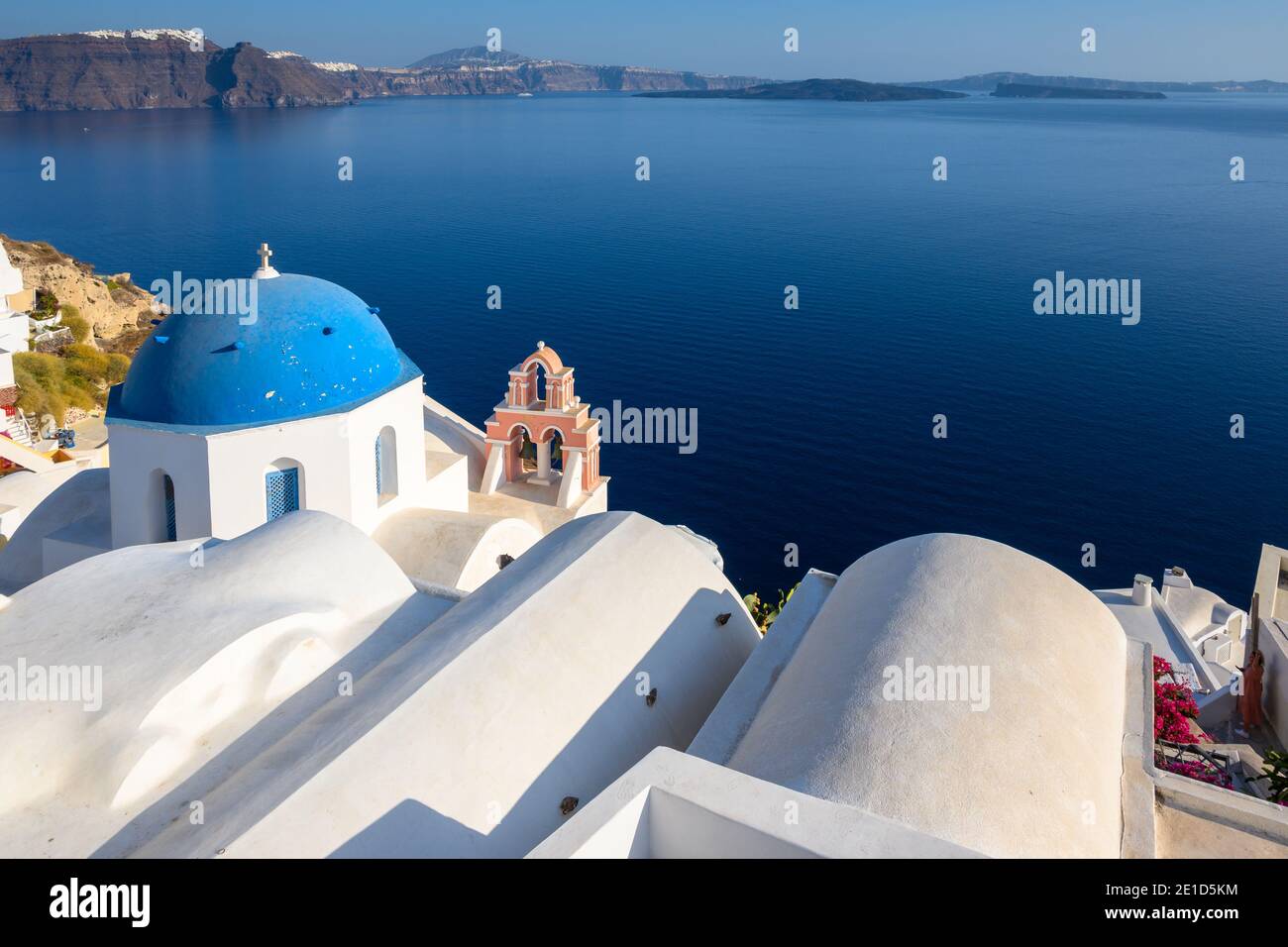 Oia village with blue dome of church building, Santorini island, Greece ...