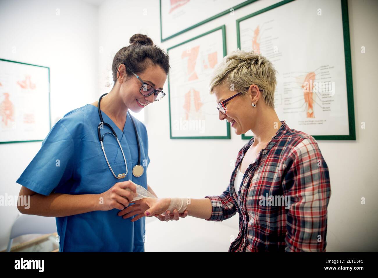 Professional carry medical nurse putting a bandage on a young girls ...