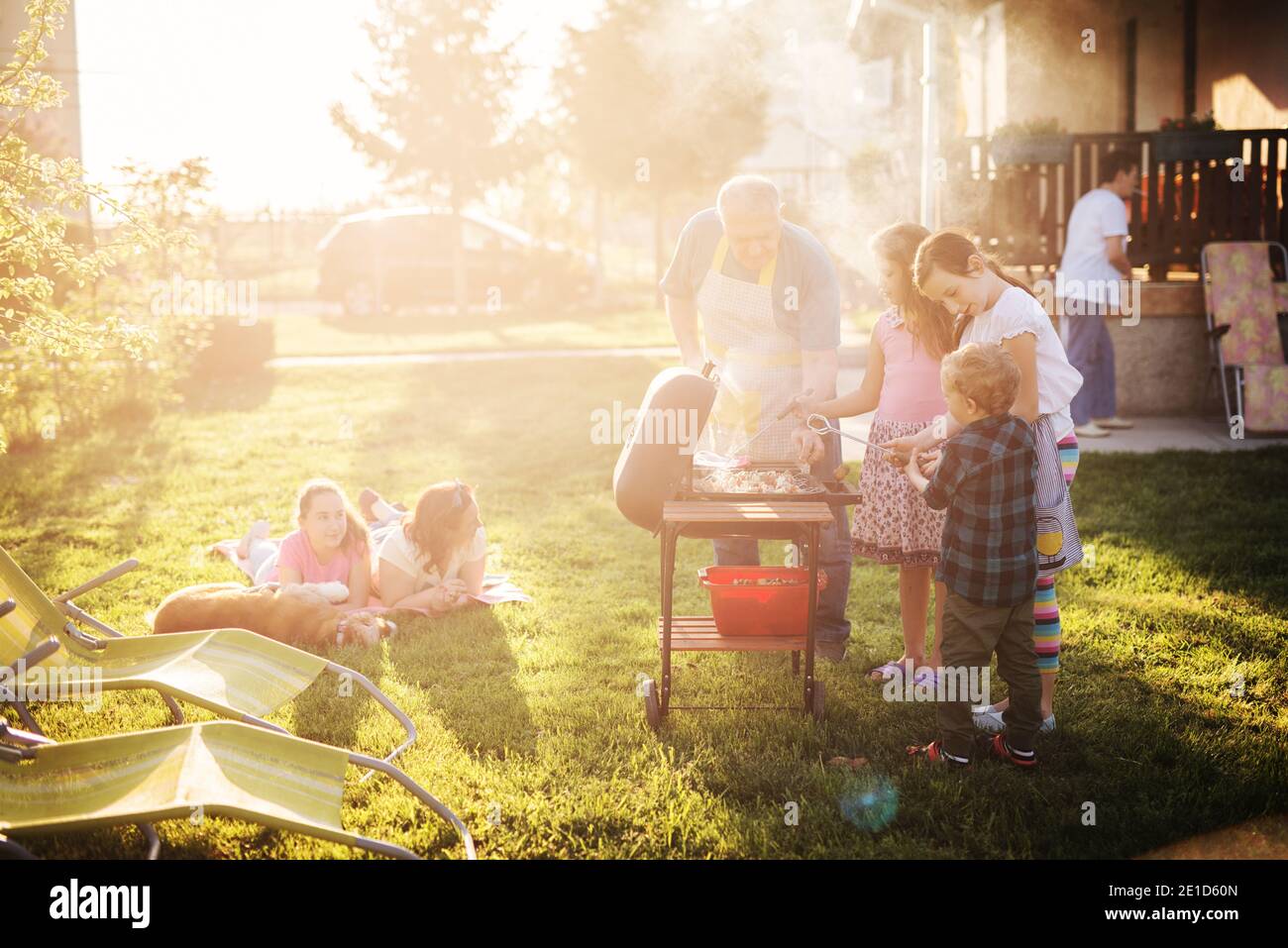 Happy family eating barbecue outdoor man hi-res stock photography and ...
